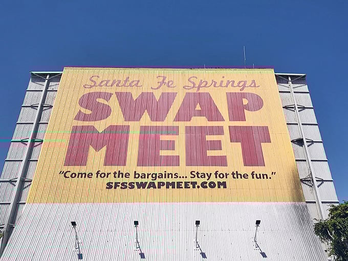The iconic yellow sign of Santa Fe Springs Swap Meet beckons bargain hunters like a desert oasis promises water.