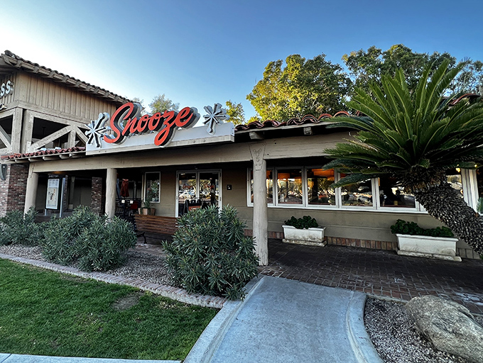 Snooze's exterior beckons with that retro sign, promising pancakes worth setting your alarm for. Morning magic happens here.