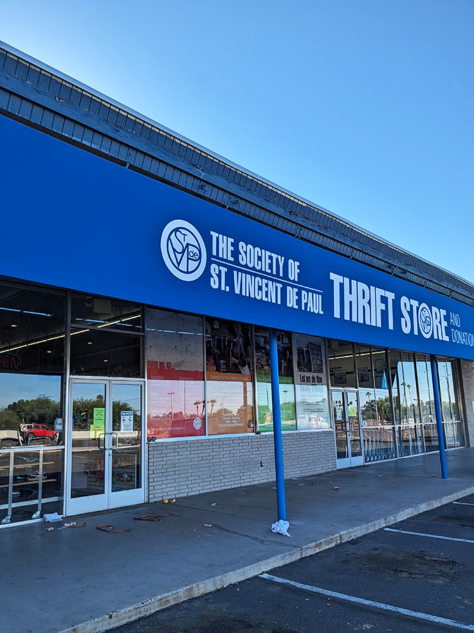 The bright blue facade of St. Vincent de Paul's thrift store beckons like a bargain-hunter's oasis in the desert heat.