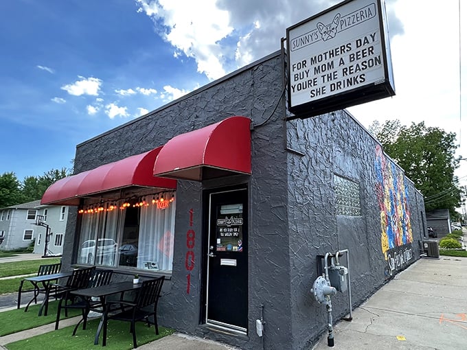 That bright red awning against the gray exterior is like a beacon calling all pizza lovers home.