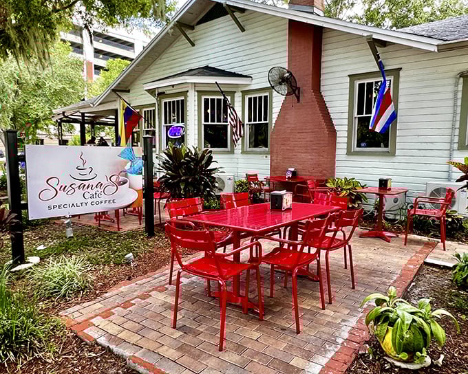 Susana's Cafe: A charming white cottage with vibrant red outdoor furniture that practically begs you to sit down for coffee and conversation.