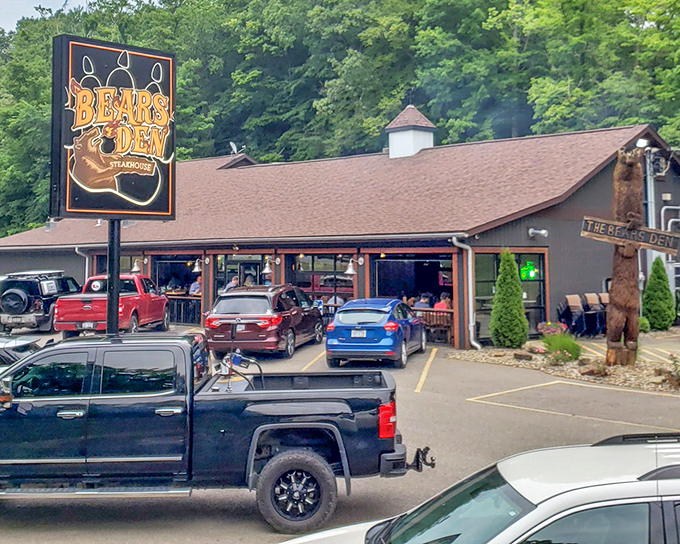 The Bear's Den Steakhouse exterior beckons with rustic charm. That glowing sign isn't just advertising&mdash;it's a beacon for steak lovers across Cambridge.