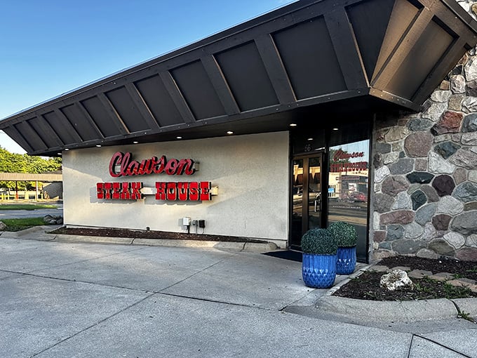 The Clawson Steakhouse's iconic stone exterior and bold red sign - a Michigan landmark where meat lovers have been making pilgrimages for decades.