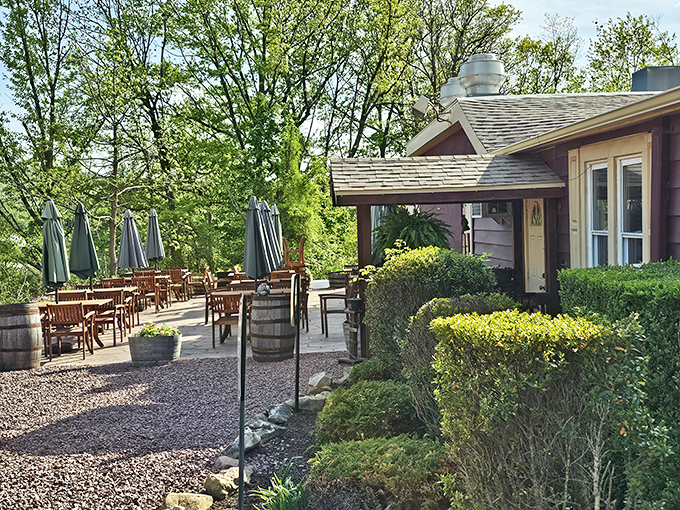 The Meating House's outdoor patio beckons with wooden tables nestled among lush greenery &ndash; nature's dining room with a side of tranquility.