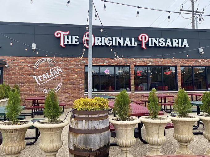 The Original Pinsaria's brick facade and string lights create the perfect setting for pizza magic to happen.