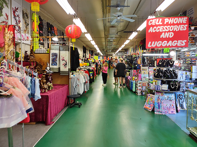 The iconic green floors of Main Gate Flea Market guide shoppers through a labyrinth of treasures where bargain hunting becomes an Olympic sport.