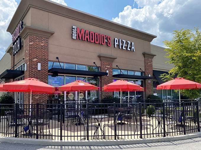 Uncle Maddio's welcomes pizza lovers with its bright storefront and cheerful red umbrellas &ndash; the perfect spot for outdoor dining on sunny Tennessee days.