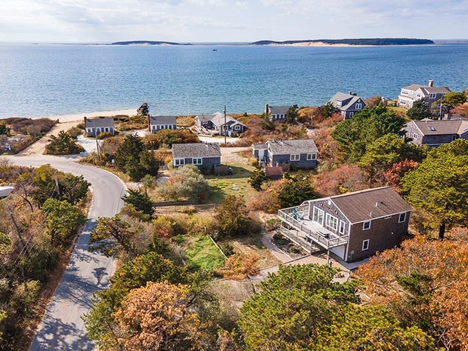Shingled cottages nestled along the shoreline like a New England dream sequence. Cape Cod living at its most postcard-perfect.