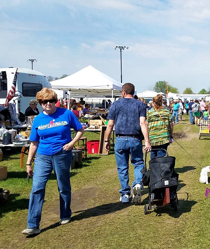 Treasure hunters navigate rows of outdoor vendor tents at What Cheer, where one person's castoffs become another's prized possessions.
