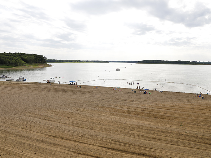 Sandy shores stretch endlessly while boats dot the horizon like floating vacation dreams come true.