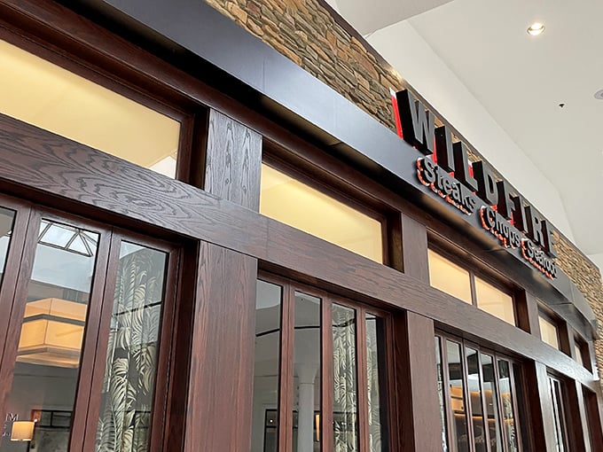 Wildfire's elegant wooden entrance frames a promise of smoky delights within. Like a portal to steak paradise!