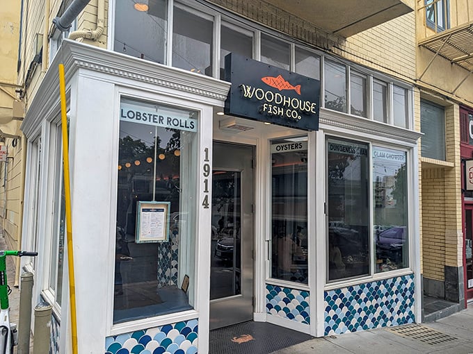 Woodhouse Fish Company's storefront promises lobster roll nirvana with its charming blue-scale tiles. Like finding a mermaid's secret lunch spot!