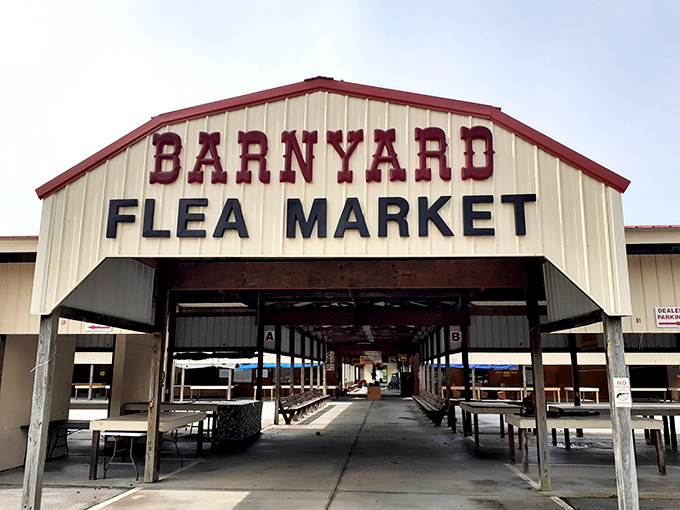 The iconic barn-style entrance to Barnyard Flea Market welcomes bargain hunters with its covered walkways and endless rows of vendor spaces.