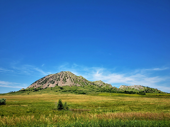 Nature's skyscraper rising from the plains, Bear Butte stands like a sleeping giant under that impossibly blue South Dakota sky.