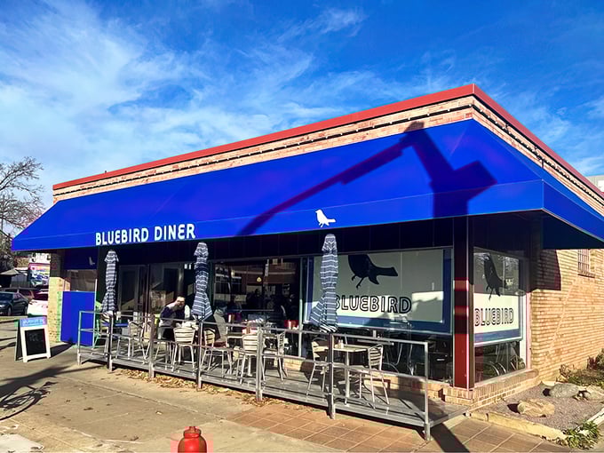 Classic diner vibes meet modern charm where red booths and friendly faces create breakfast magic daily.