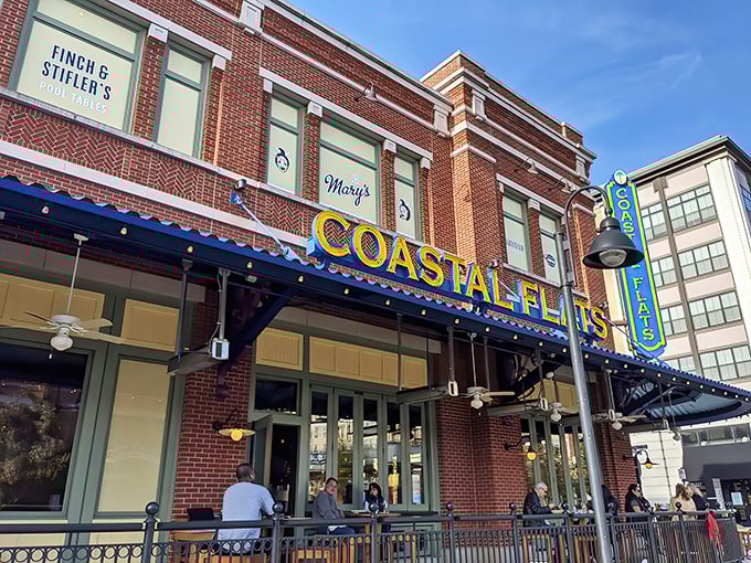 Outdoor dining at Coastal Flats feels like a mini-vacation. That yellow sign promises seafood treasures without the long drive to the coast!