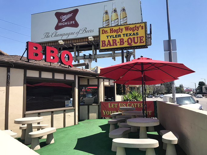 Red umbrellas and picnic tables outside &ndash; where BBQ dreams come true without the fancy frills.