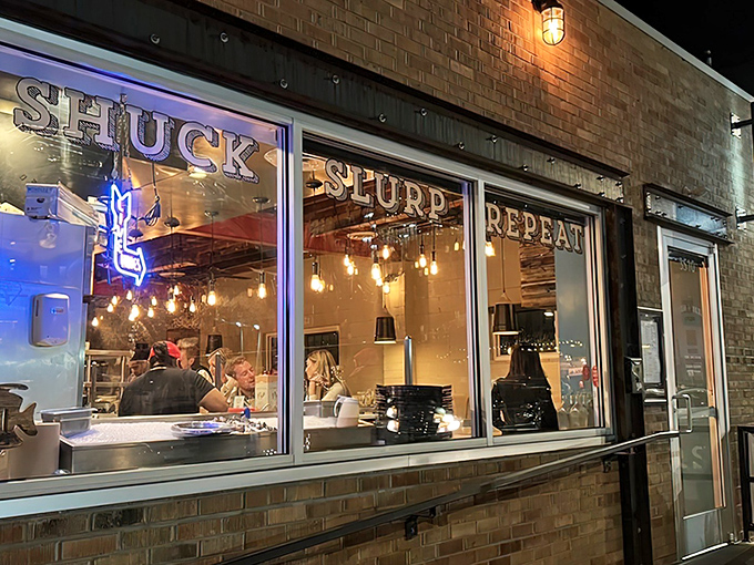 Night falls, but Fish N Beer's window glow promises seafood treasures that make you forget you're a thousand miles from any ocean.