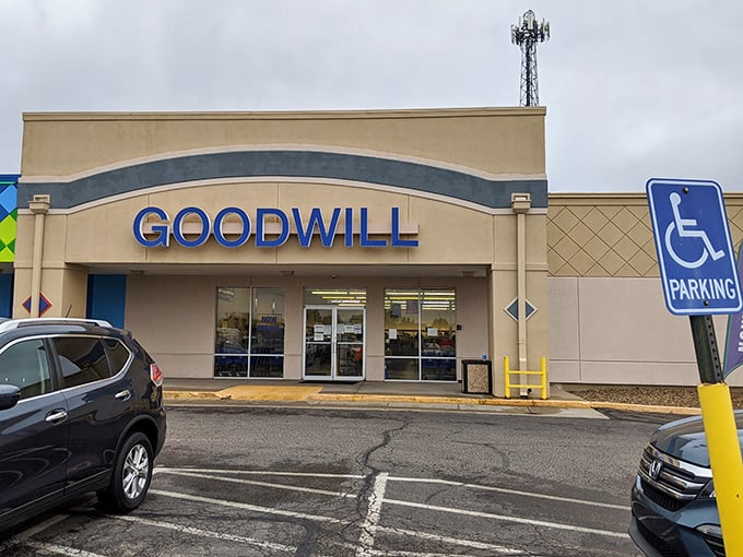 Blue skies may be hiding, but Goodwill's welcoming fa&ccedil;ade stands ready&mdash;a beacon of second-hand possibilities under Kansas's moody afternoon canvas.