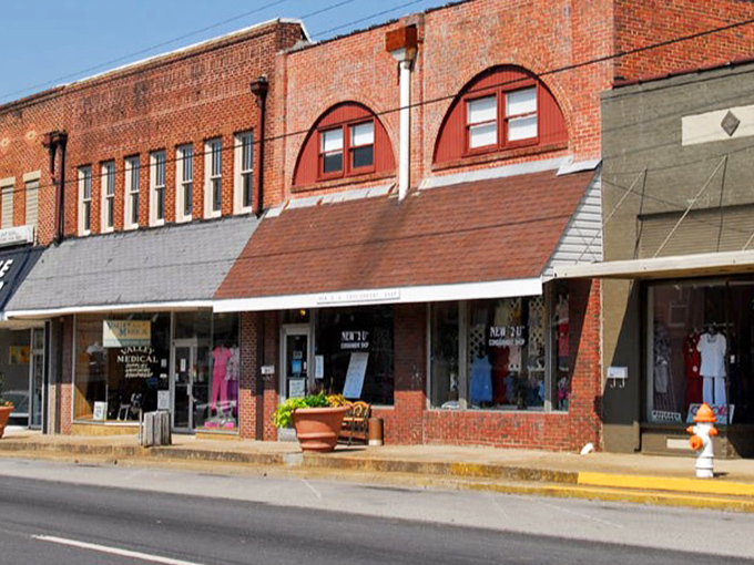 Historic storefronts whisper tales of simpler times when neighbors knew your coffee order. 