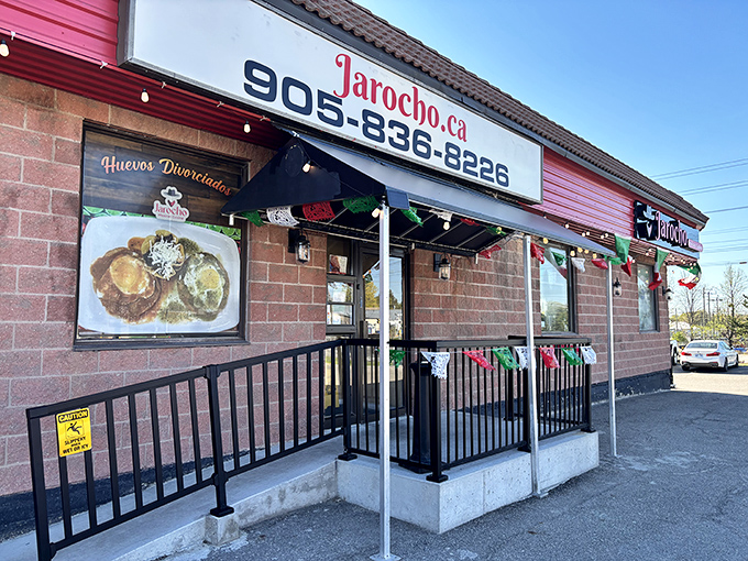 Colorful Mexican bunting decorates Jarocho's entrance, while a tempting food photo showcases their delicious breakfast offerings. The perfect morning seafood stop!