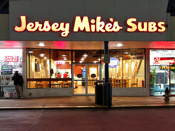 Night falls, but Jersey Mike's glowing sign promises sandwich salvation. Where bread, meat, and cheese become something magical.