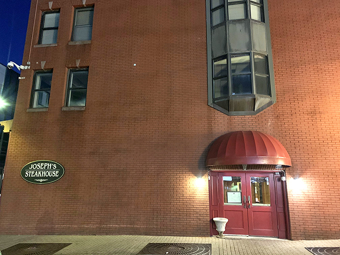 That elegant brick entrance with the burgundy awning? It's like the pearly gates for carnivores.
