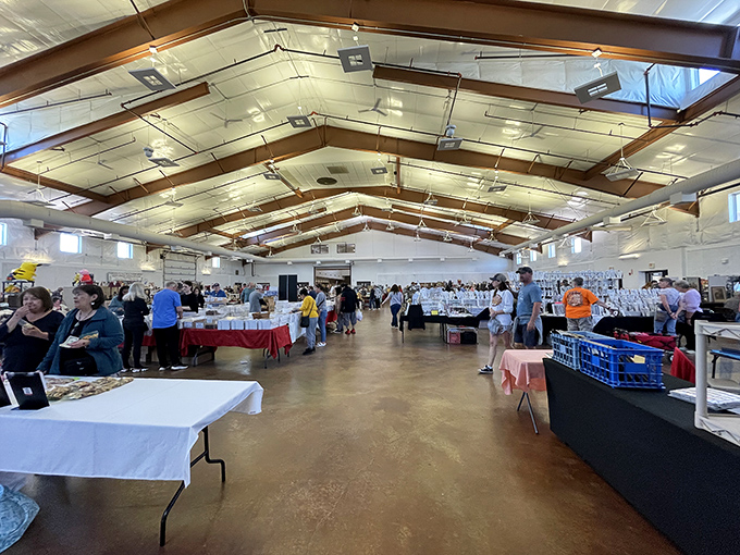 The indoor section of Kane County Flea Market offers climate-controlled comfort for shoppers exploring rows of vendor tables.