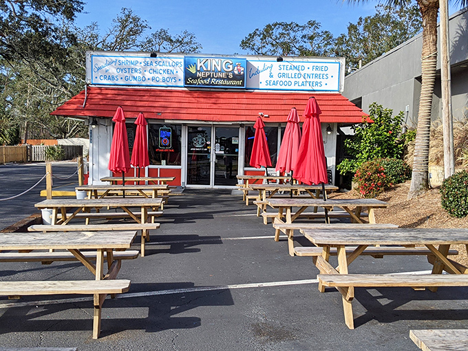 Picnic tables outside King Neptune's Seafood Restaurant offer the perfect spot to crack into crab legs while soaking up Gulf Shores sunshine.