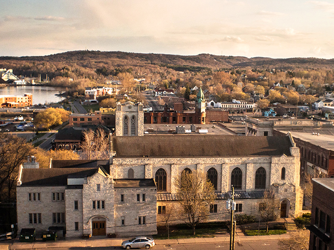 Golden autumn light bathes this lakeside town, creating the perfect postcard moment from above.