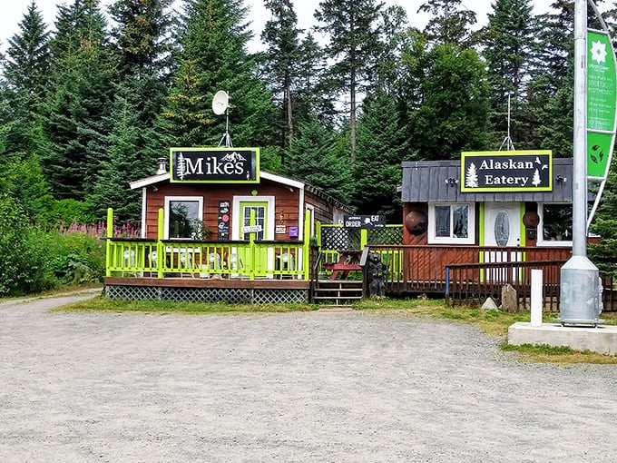 Two tiny cabins, one big flavor punch. Mike's wooden charm and that "Alaskan Eatery" sign promise authentic local delights.