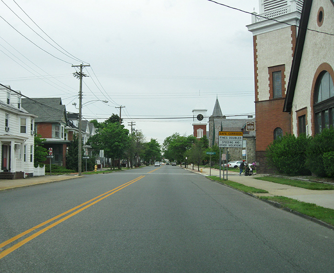 Main Street stretches into the distance, lined with well-preserved buildings where neighbors still greet each other by name.