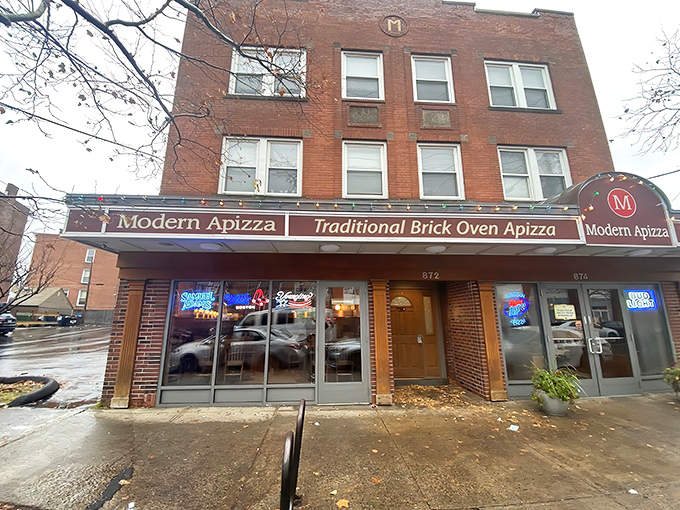 Rain or shine, Modern Apizza's storefront beckons with the promise of coal-fired magic. Those neon beer signs in the window? Just a bonus to the main attraction.