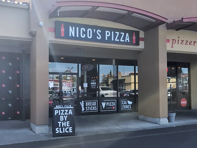No frills, just thrills at Nico's Pizza. That "Pizza by the Slice" sign is like a beacon of hope for hungry shoppers.