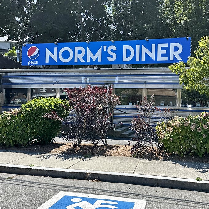 That blue Pepsi sign has guided hungry souls to Norm's for decades. Beneath it, comfort food awaits like an old friend who always remembers your name.