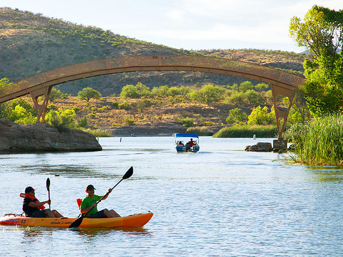 Nature's playground awaits! Kayakers glide under the bridge at Patagonia Lake like explorers in their own backyard adventure.