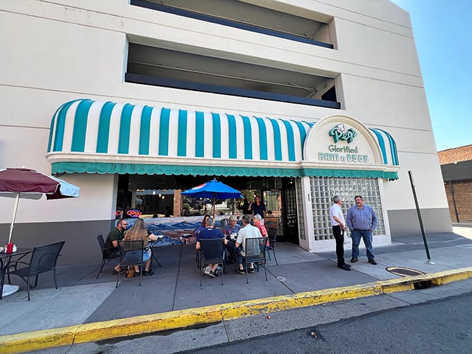 Breakfast enthusiasts gather under Peg's cheerful striped canopy, where coffee flows freely and pancake stacks reach impressive heights. The morning buzz is contagious!