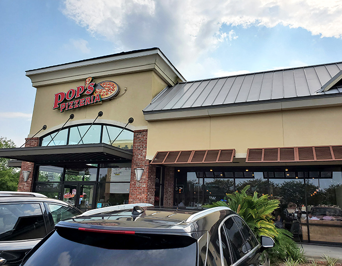 Pop's Pizzeria stands proud against the sky, promising cheesy treasures within those brick-trimmed walls.