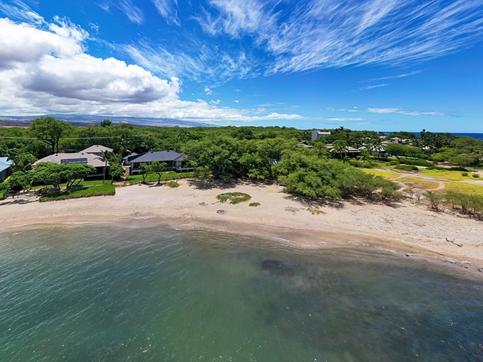 Bird's eye bliss! Puako's turquoise waters and sandy shores create nature's perfect sandwich with those cozy homes as the filling.