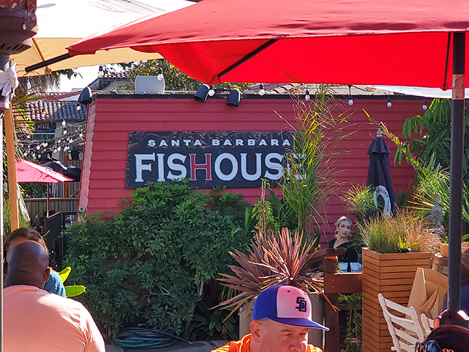 Red umbrellas and lush greenery create the perfect backdrop for seafood bliss at Santa Barbara FisHouse. Vacation vibes without leaving California!