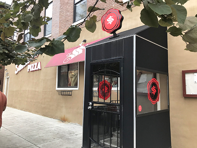 Look for the distinctive red and black logo! The entrance to delicious original square pizza awaits you here.