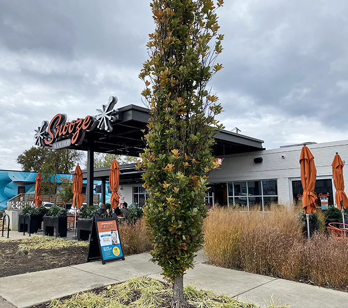 Morning magic happens under these orange umbrellas, where East Nashville's breakfast crowd gathers for pancake perfection.