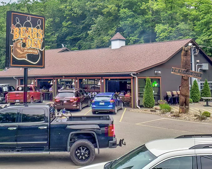 Look for the carved bear welcoming hungry travelers. The full parking lot is your first clue to the treasures sizzling inside.