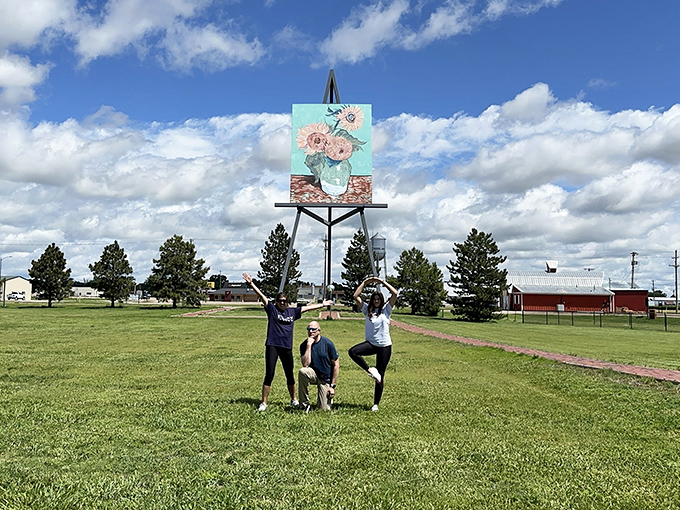Strike a pose! Visitors find creative ways to "hold up" this massive masterpiece, giving new meaning to the phrase "interactive art experience."