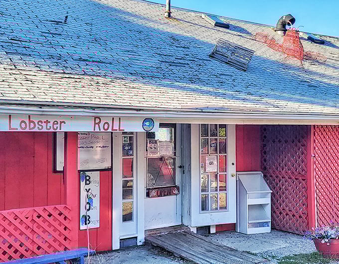 The Lobster Pool's entrance proudly advertises their famous lobster rolls, inviting hungry visitors to step inside this Rockport seafood landmark.