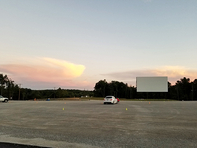Twilight's golden glow signals showtime approaching, as the empty lot prepares for its nightly transformation into a community gathering space.