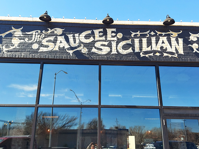 That bold white lettering against black brick? It's not just a sign, it's a promise of Sicilian magic waiting inside.