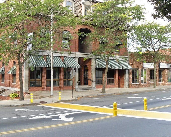 Historic brick buildings line Ware's main street, where green awnings invite you into local shops that won't break the bank.