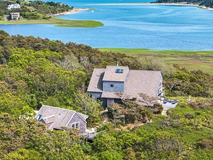 Where land meets water in perfect harmony. Wellfleet's coastal homes perch above marshlands that glow golden in autumn light.