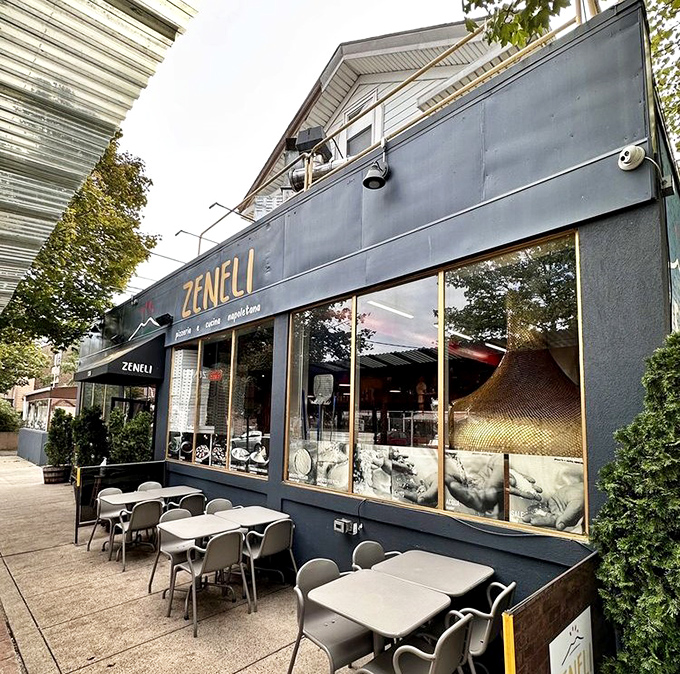 Outdoor dining at Zeneli feels like stumbling upon a hidden piazza. That copper-domed oven visible through the window is working overtime on pizza perfection.